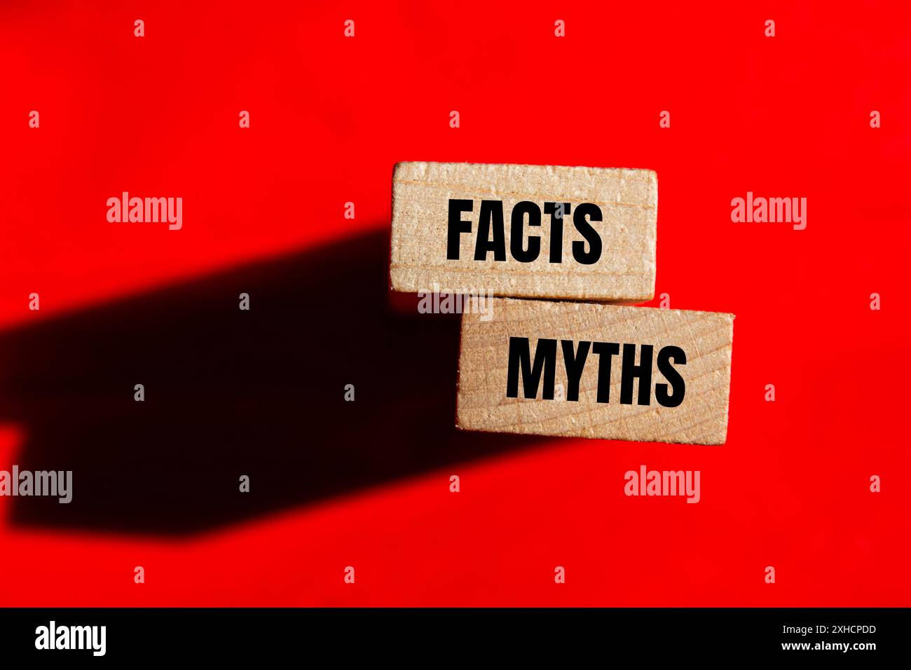 Facts and myths words written on wooden blocks with red background ...