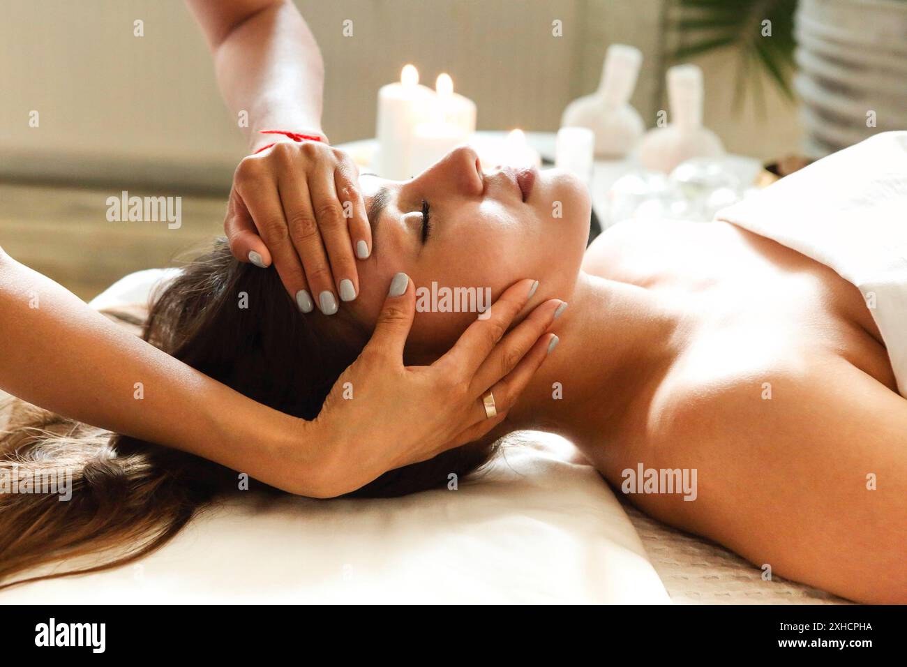 Side view of ethnic female client with closed eyes relaxing during spa session in salon Stock ...