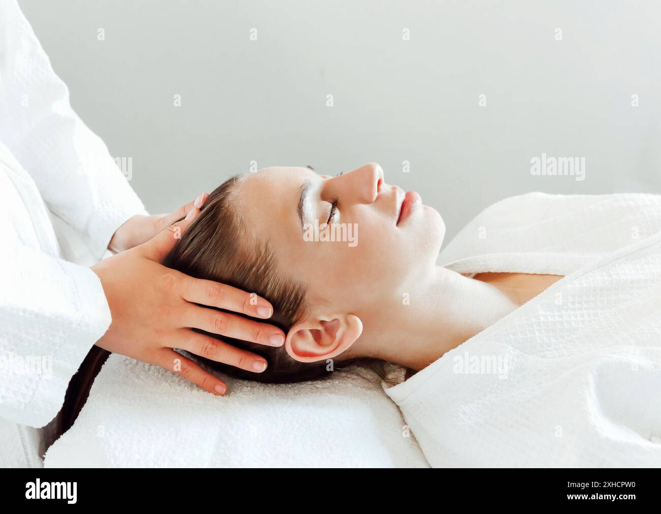 Side view of ethnic female client with closed eyes relaxing during spa session in salon Stock ...