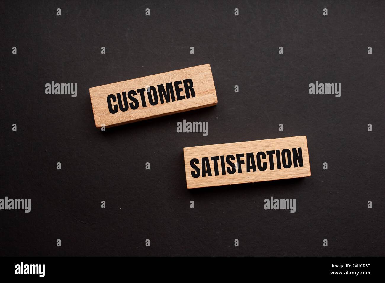 Customer satisfaction message written on wooden blocks with black ...