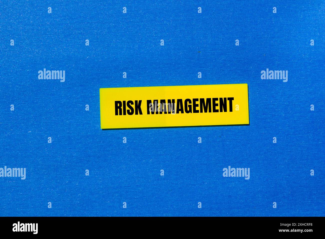 Risk management message written on yellow paper with blue background ...