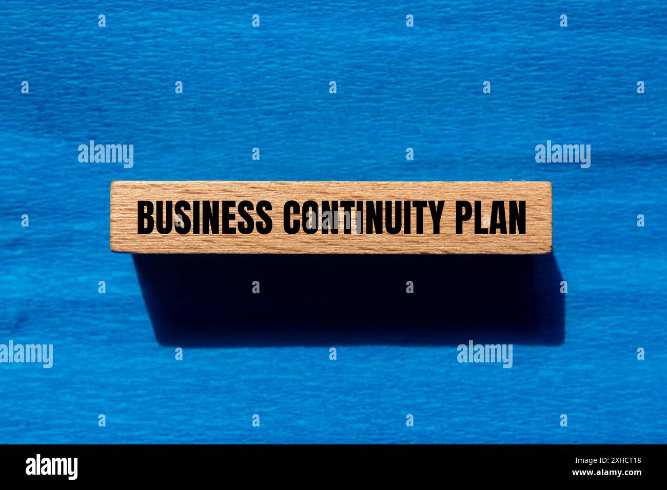 Business continuity plan message written on wooden block with blue ...