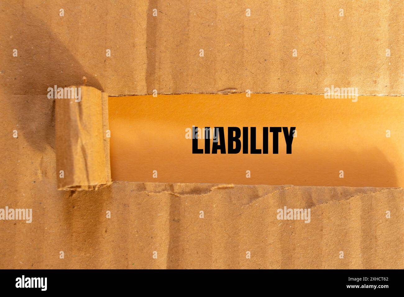 Liability message written on ripped paper with color background ...