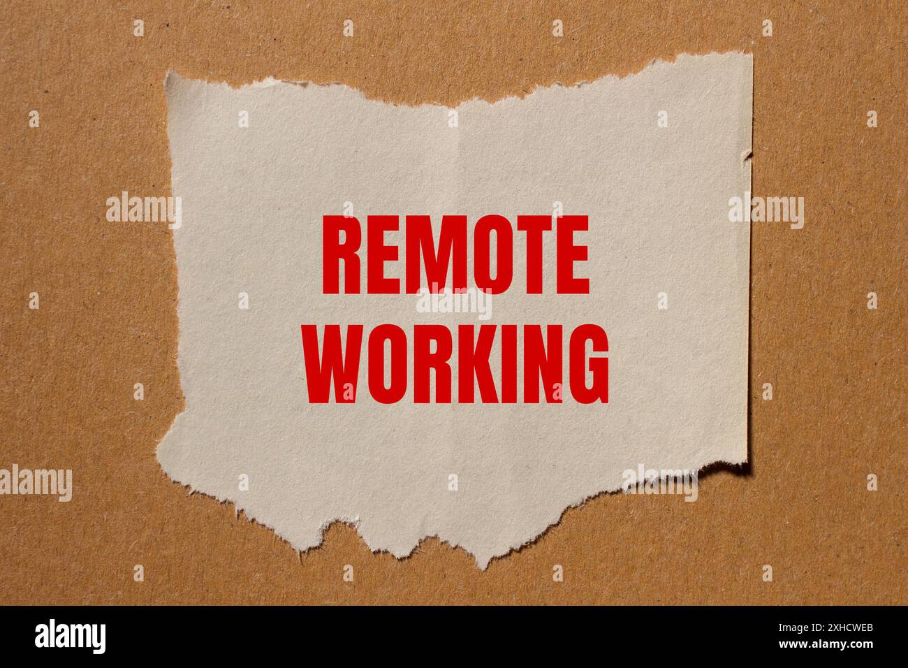 Remote working message written on ripped paper with cardboard ...