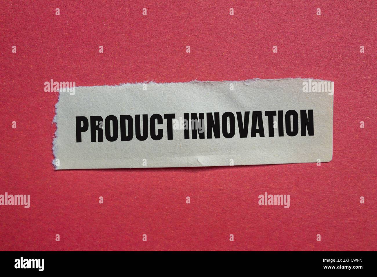 Product innovation message written on ripped paper with red background ...