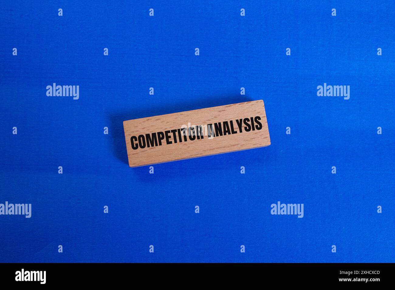 Competitor analysis message written on wooden block with blue ...