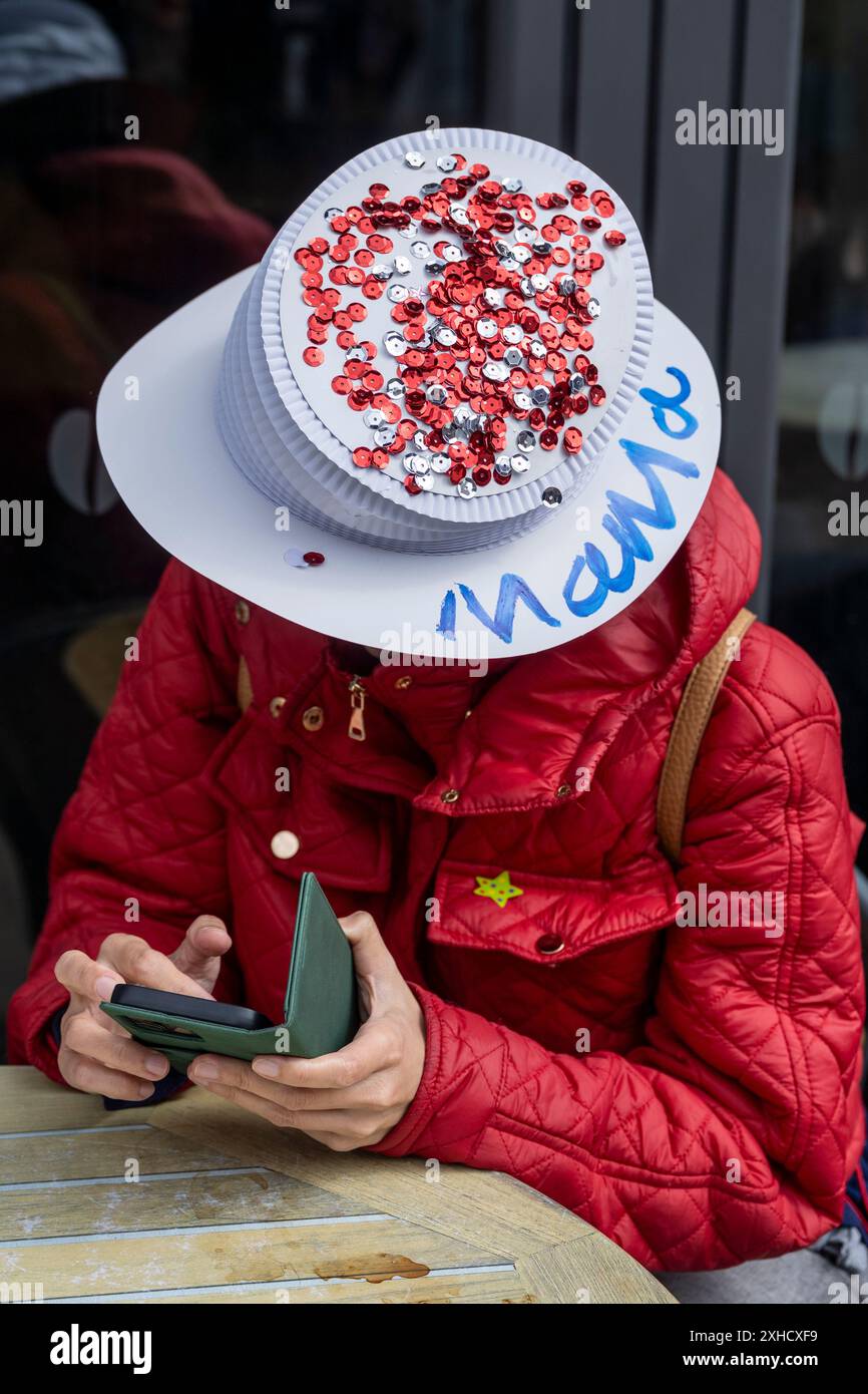 Chesham, UK. 13 July 2024. A visitor wearing a hat attends Hats Off ...