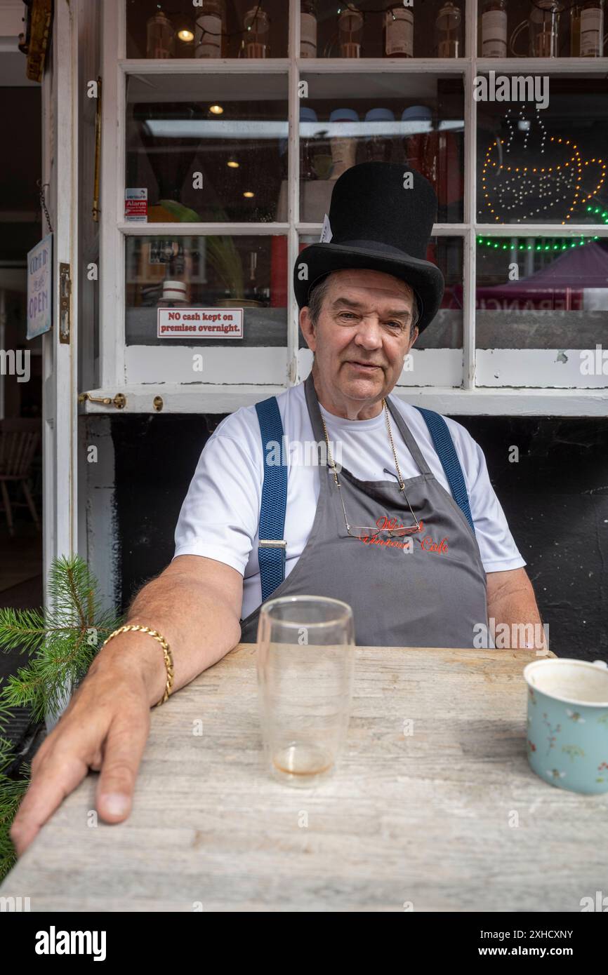 Chesham, UK. 13 July 2024. A shop owner wearing a hat at Hats Off ...