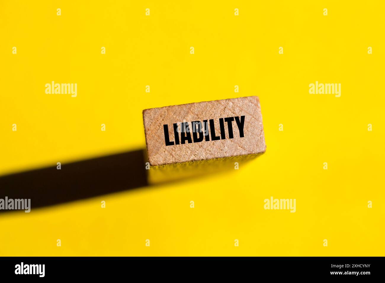 Liability message written on wooden block with yellow background ...