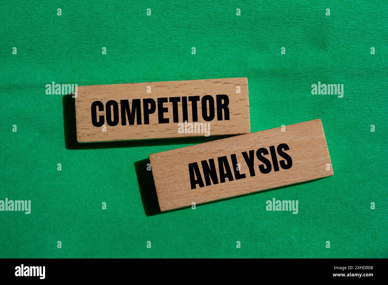 Competitor analysis message written on wooden blocks with green ...