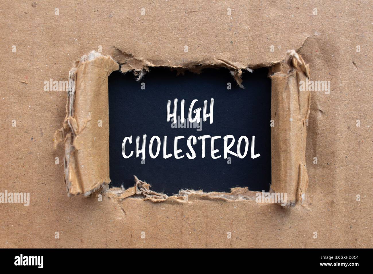 High cholesterol message written on ripped cardboard paper with black background. Conceptual ...