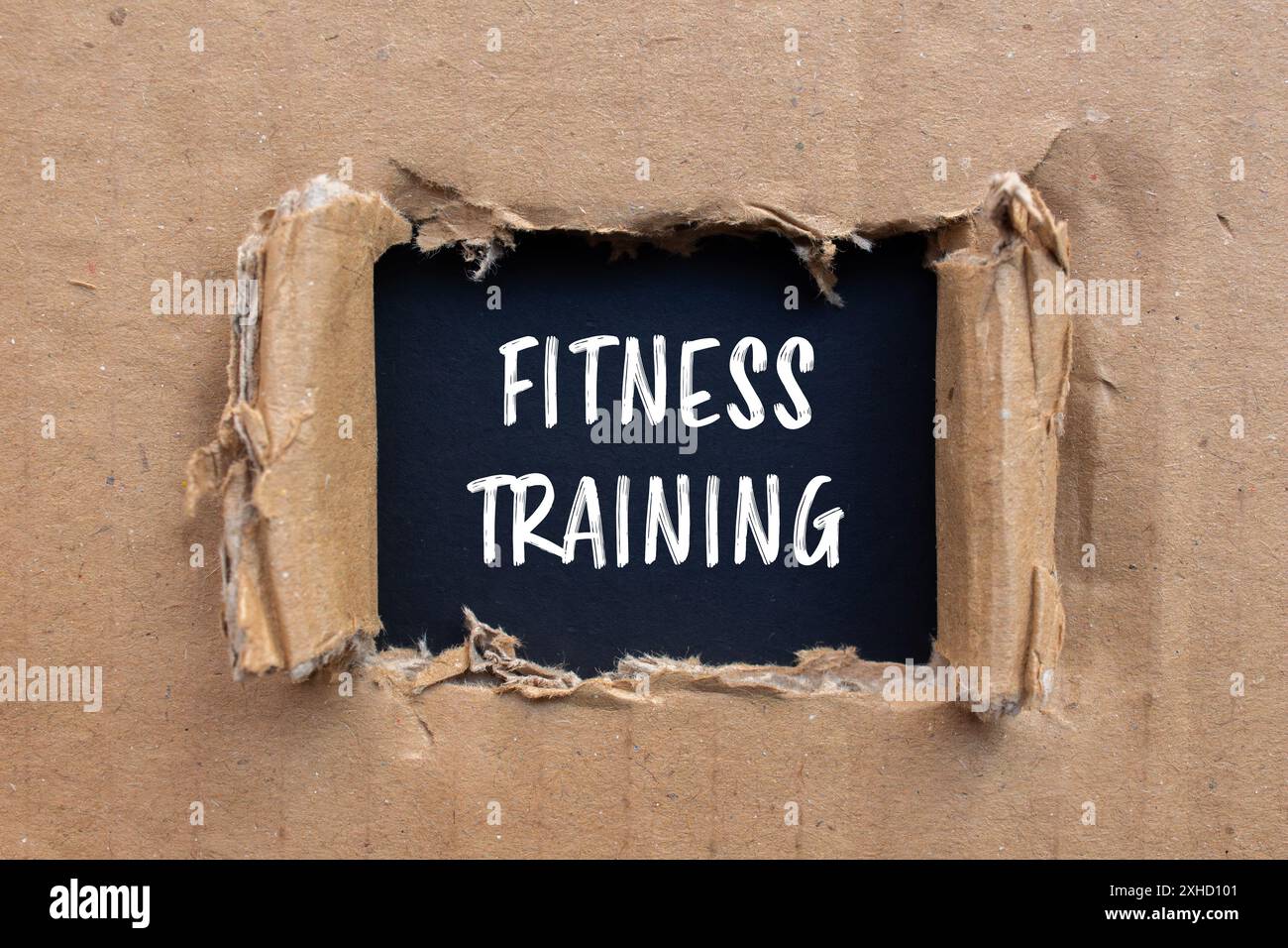 Fitness training message written on ripped cardboard paper with black ...