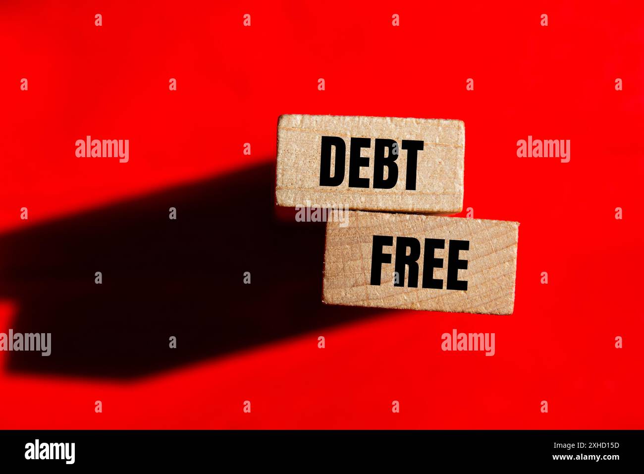 Debt free words written on wooden blocks with red background ...