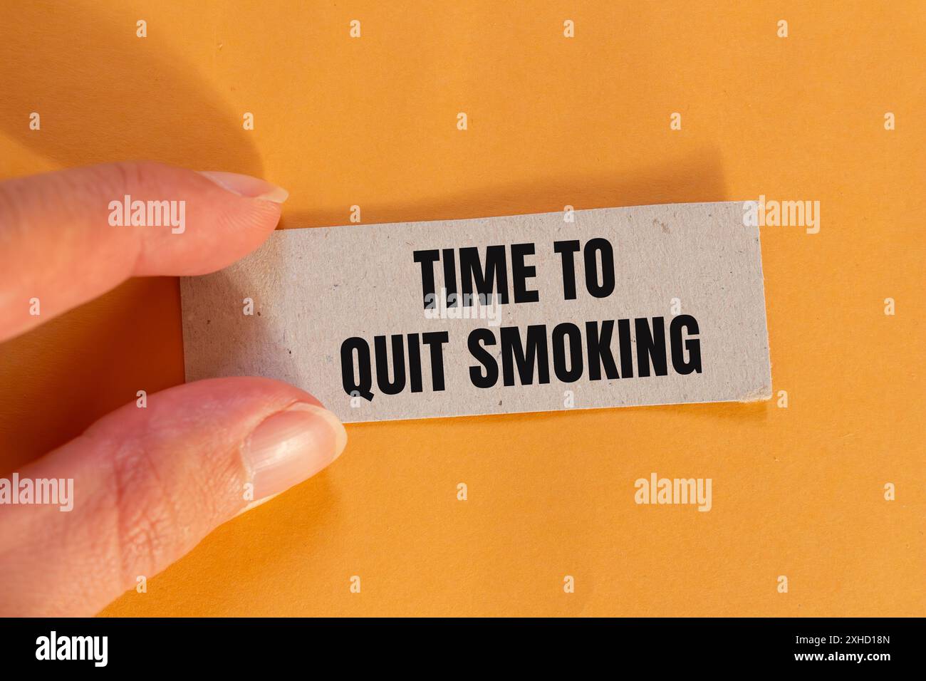 Time to quit smoking message written on ripped paper piece with orange ... Time to quit smoking message written on ripped paper piece with orange ...