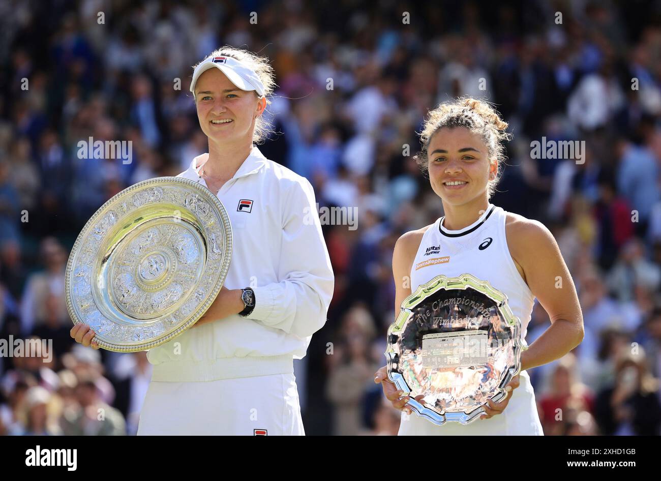 Barbora Krejcikova of Czech Republic (L) holds a trophy with Jasmine Paolini of Italy after ...