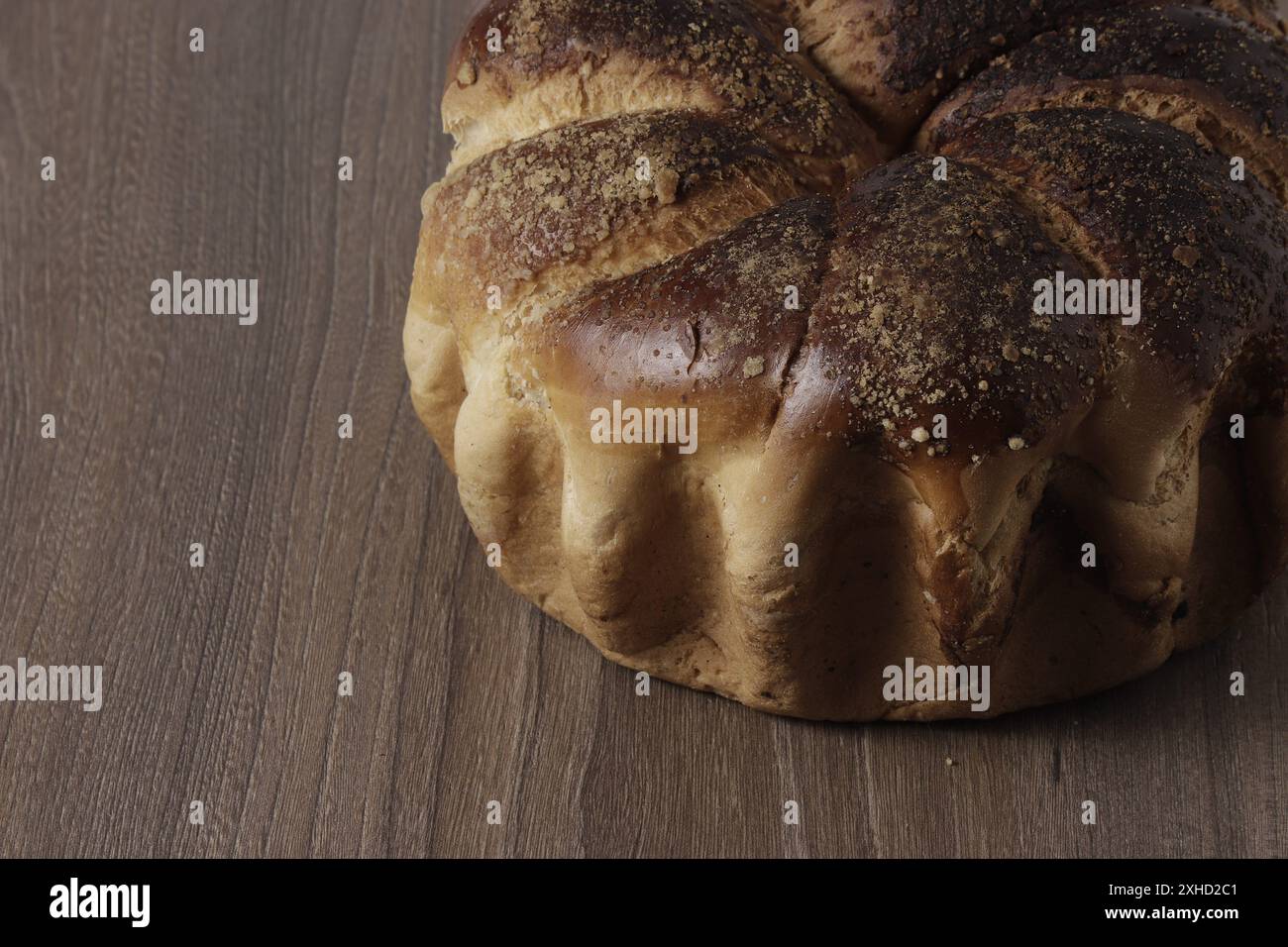 A whole loaf of bread is shown at the top of the frame on a table ...