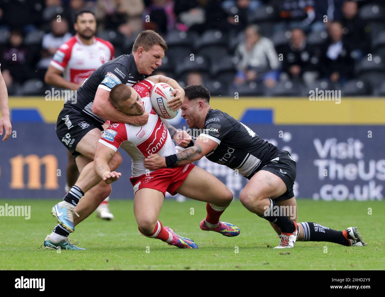 Hull FC’s Jordan Lane and Yusuf Aydin tackle Hull KR’s Mikey Lewis ...
