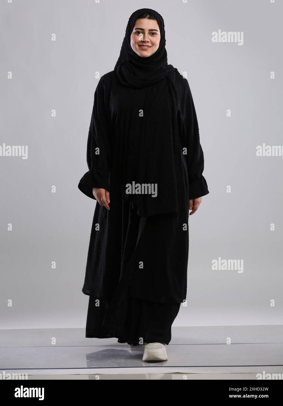 saudi arabian woman lady standing wearing hijaab walking and smiling from front side Stock Photo ...