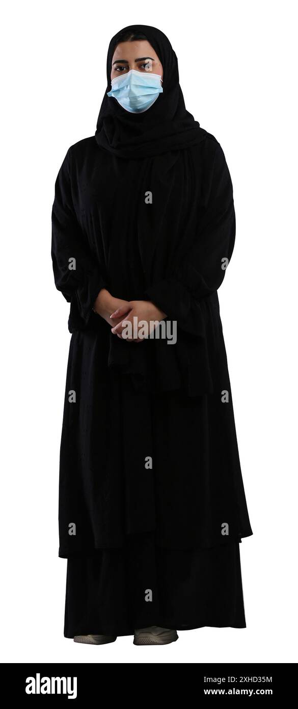 saudi arabian woman lady standing wearing hijaab and mask looking infront side view smiling ...