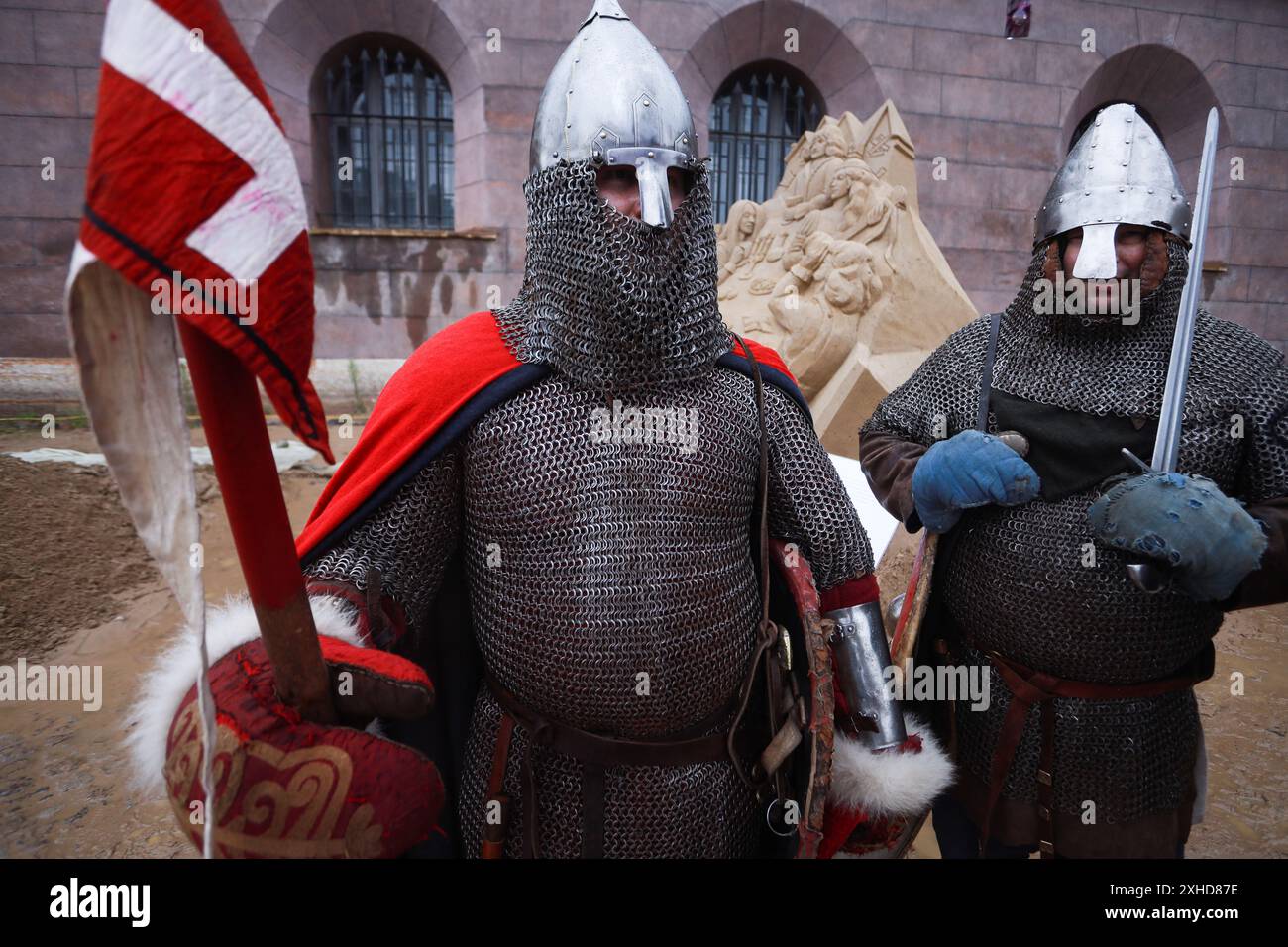 Animators dressed as knights with swords near sand sculptures during ...