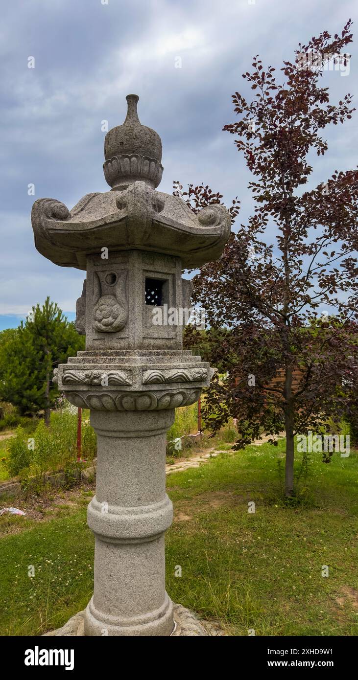 Background with Japanese traditional old stone lantern with moss ...