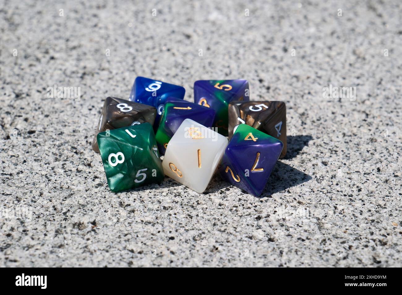 Colorful dice with numbers on a concrete background Stock Photo - Alamy