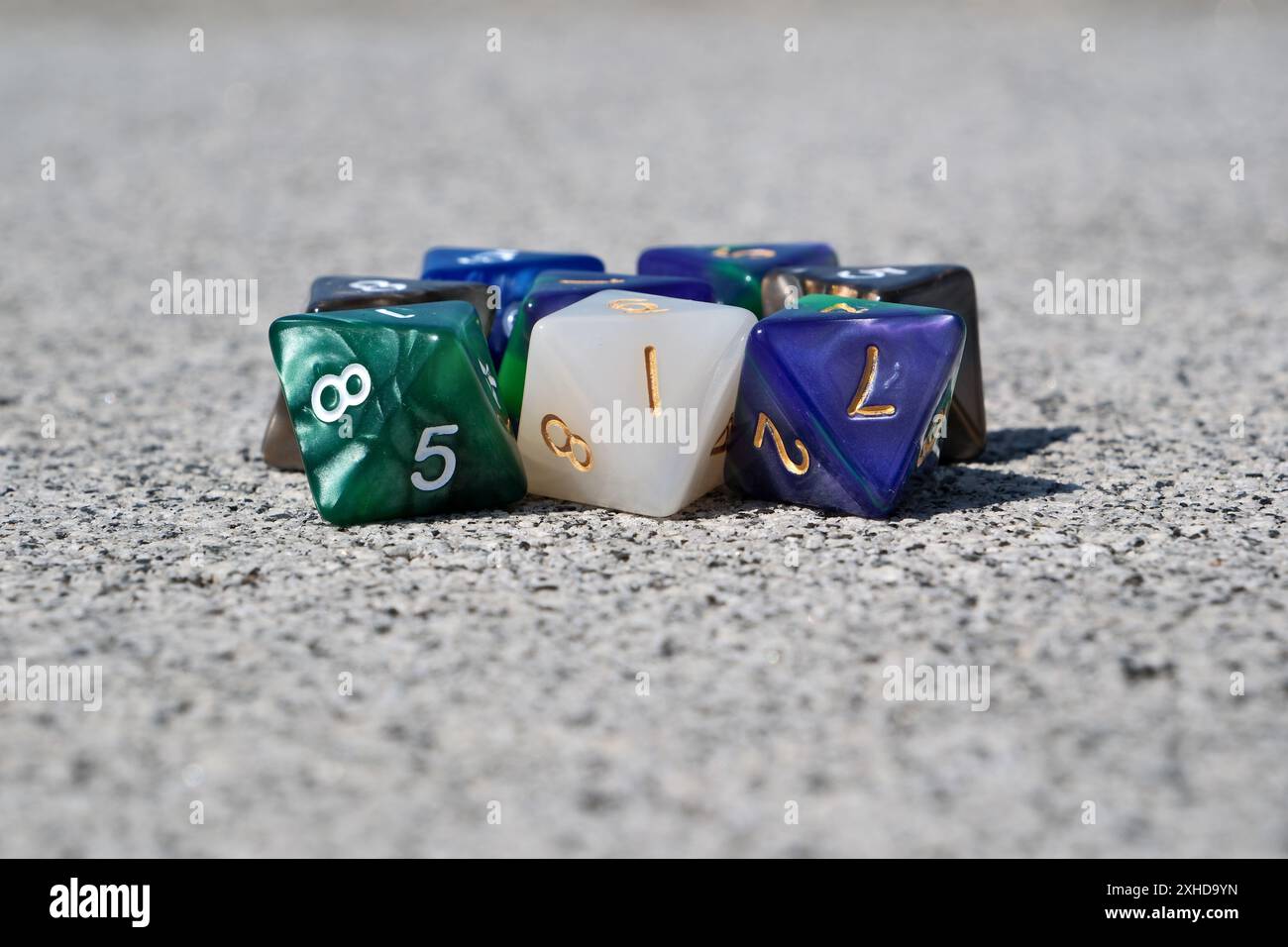 Colorful dice with numbers on a concrete background Stock Photo - Alamy