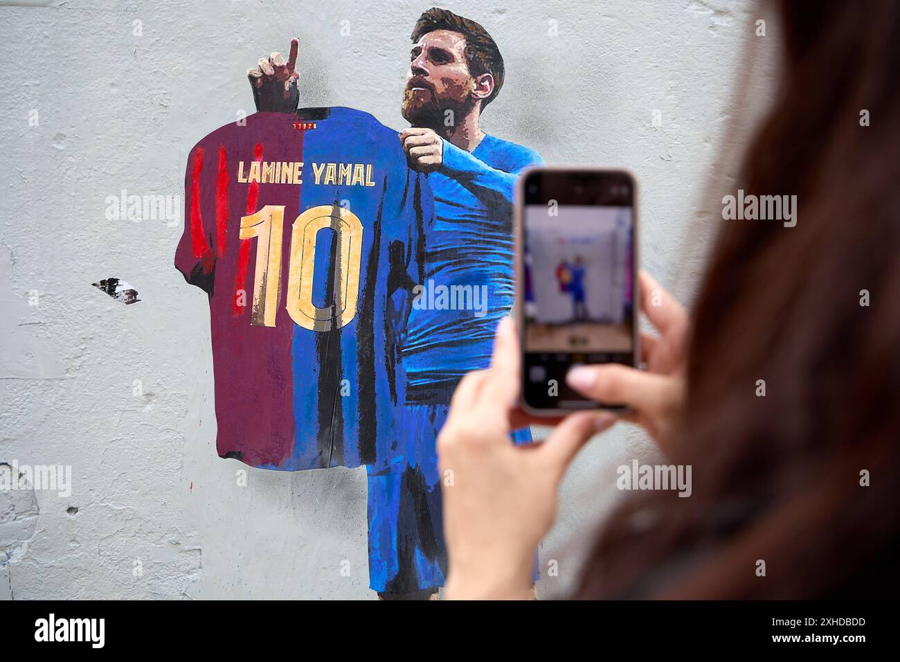 Graffiti by the artist TV Boy featuring Leo Messi holding an FC ...