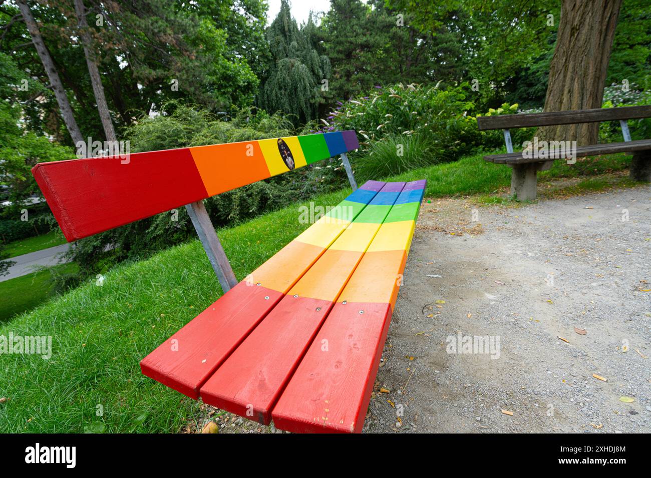 Salzburg, Austria. July 1, 2024. a rainbow bench in a city center park ...