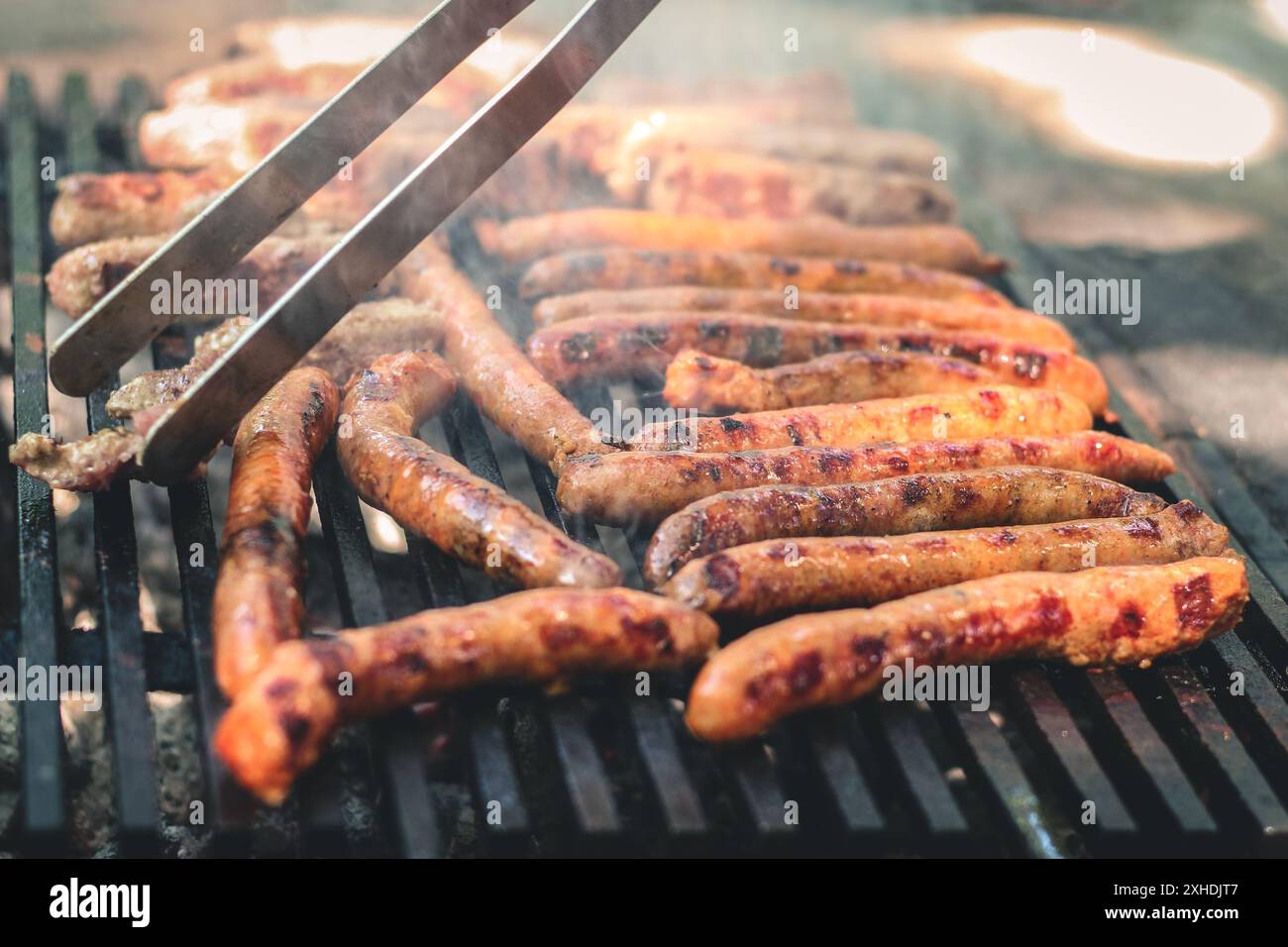 Grilled sausages with smoky char marks on a black barbecue grill Stock ...