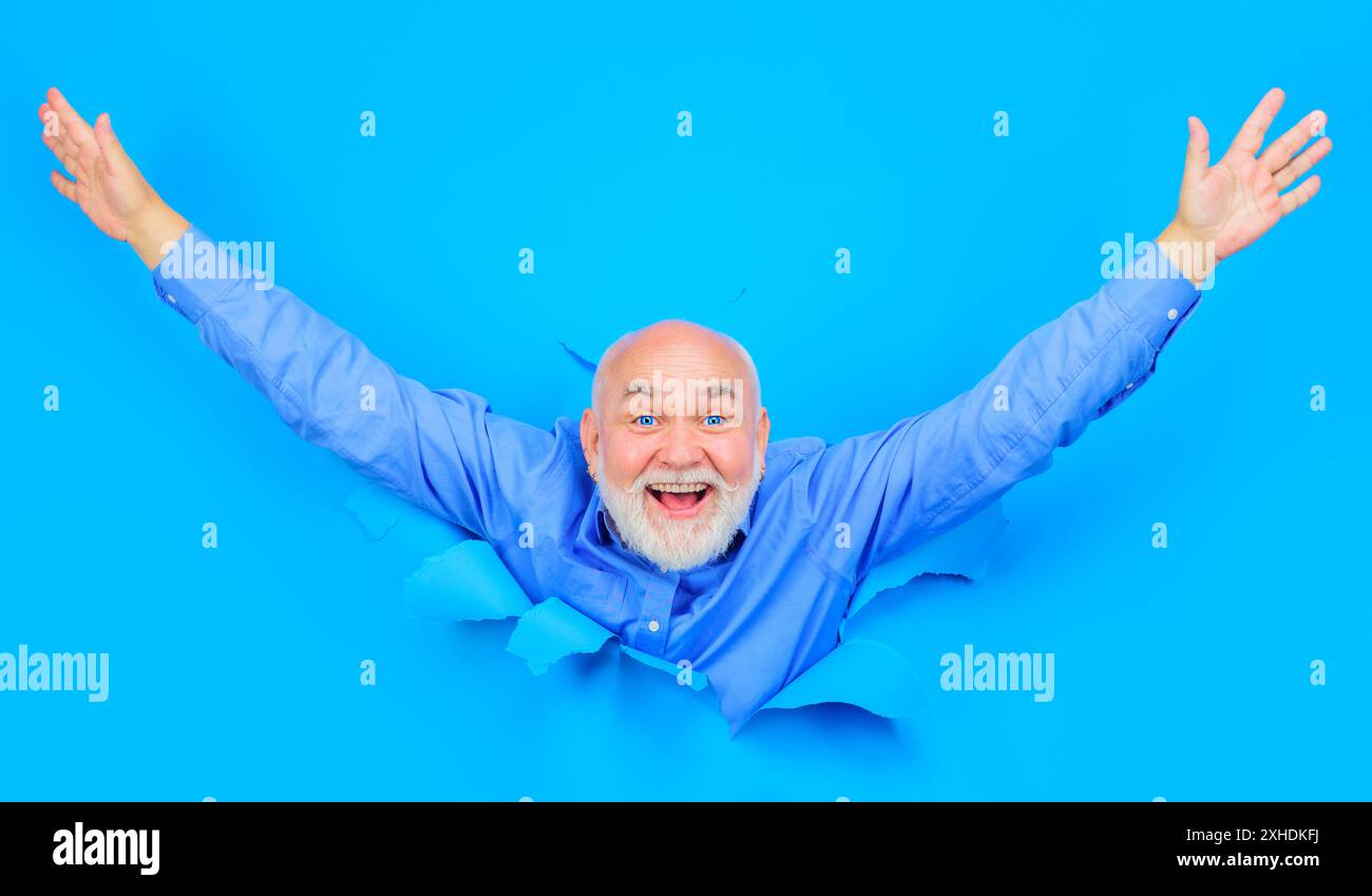 Happy Bearded Man Looks Through Hole In Blue Paper Smiling Old Man In