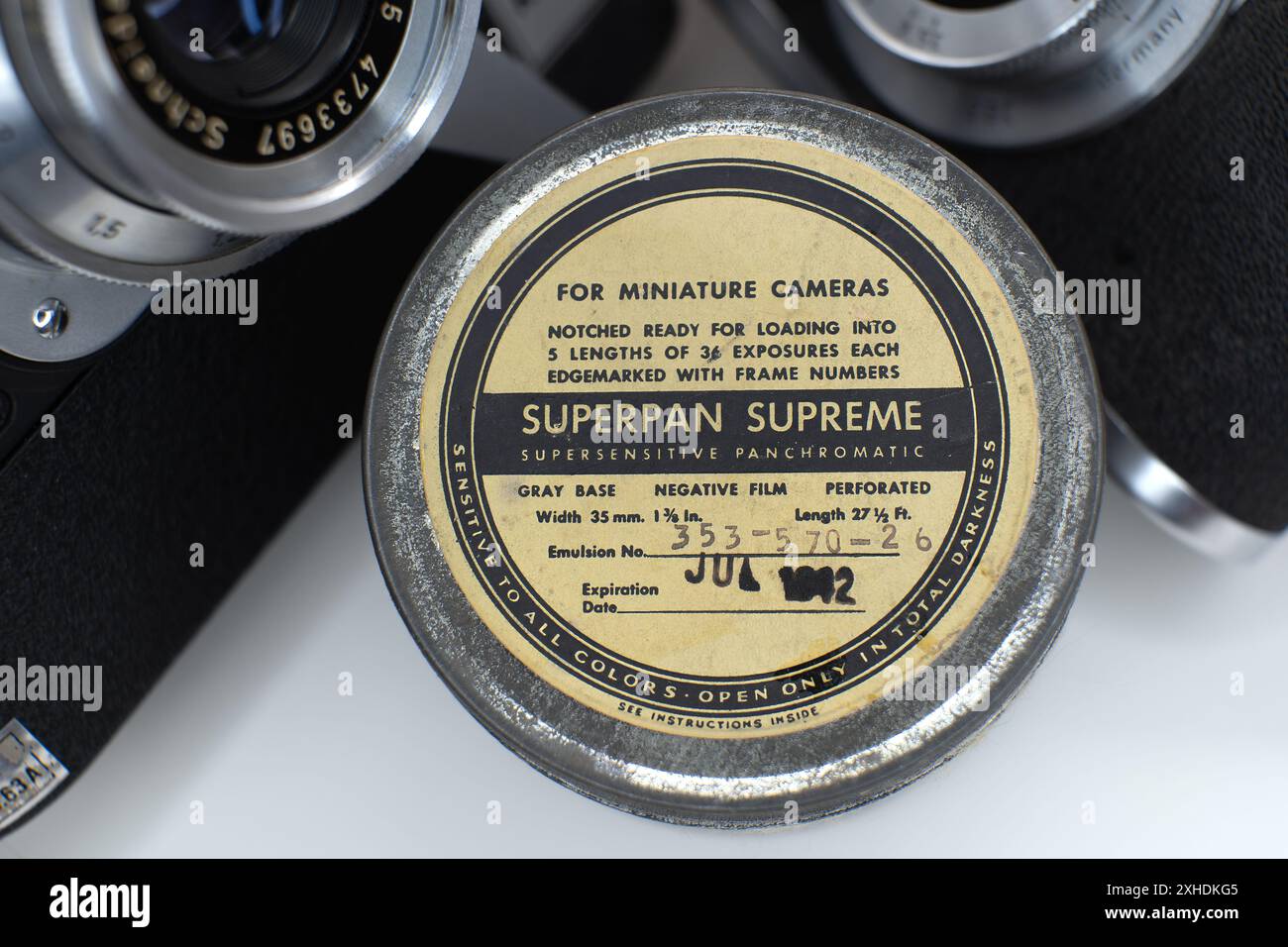 Tin box for negative film roll, historical with two historical cameras ...