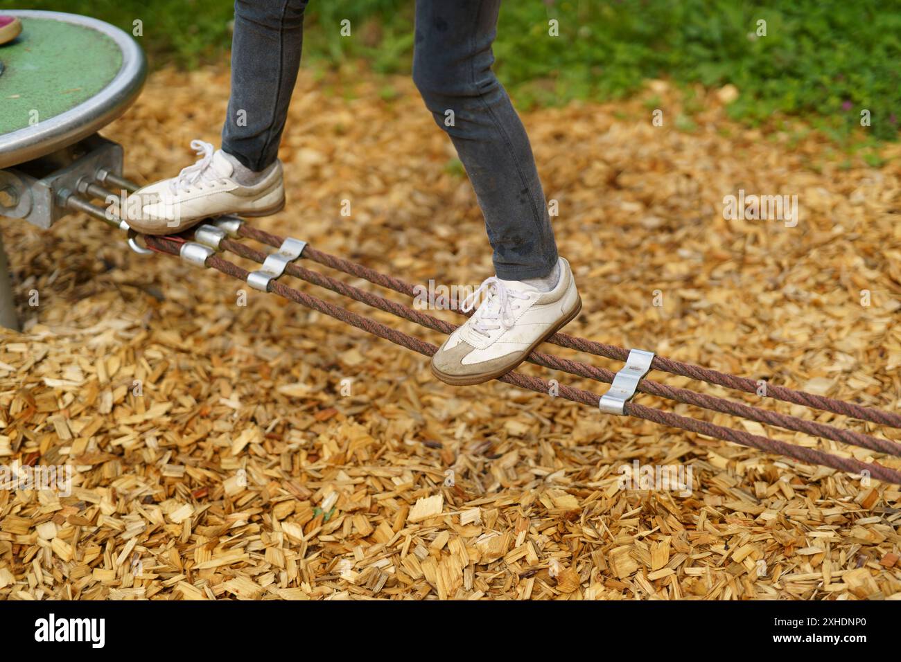 Children's legs balance on a rope. Children's feet in shoes close-up ...
