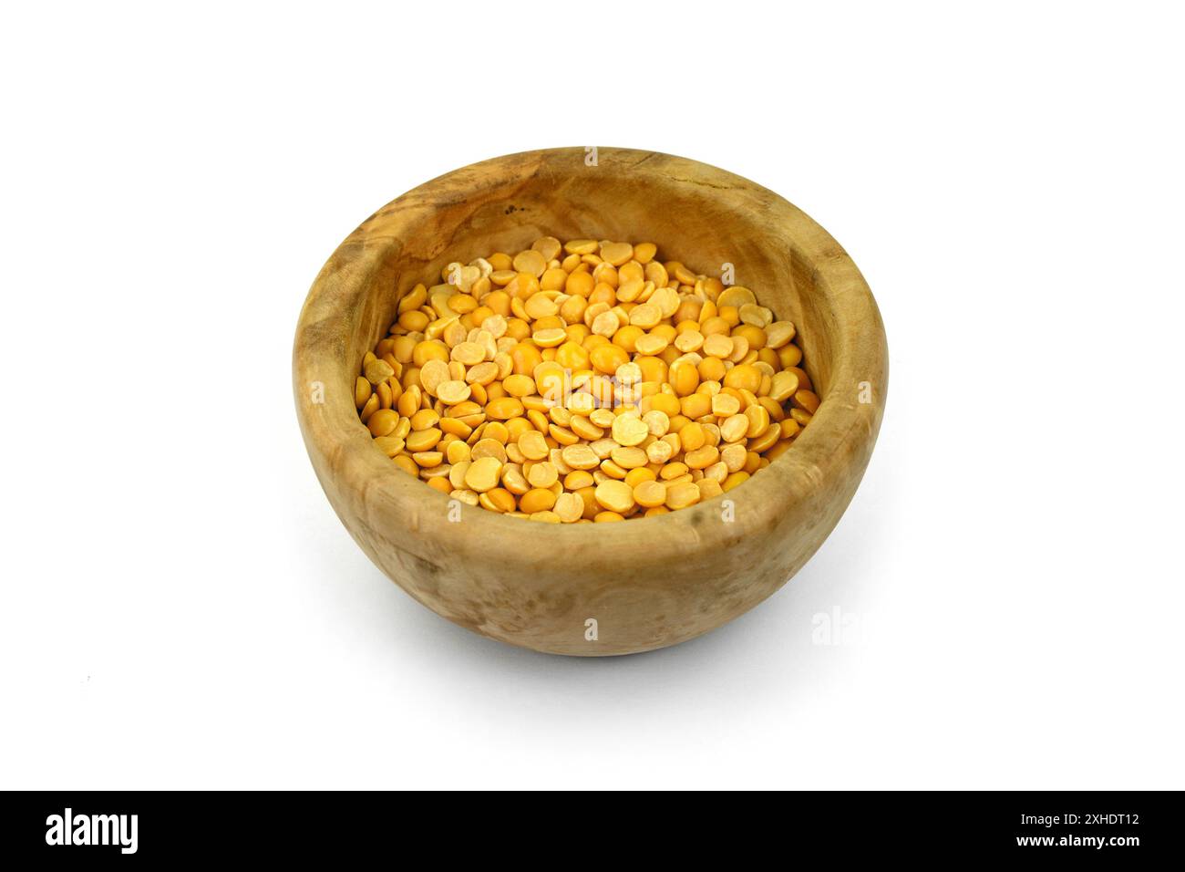 Toor dal or split yellow lentils in a wooden bowl isolated. Split ...
