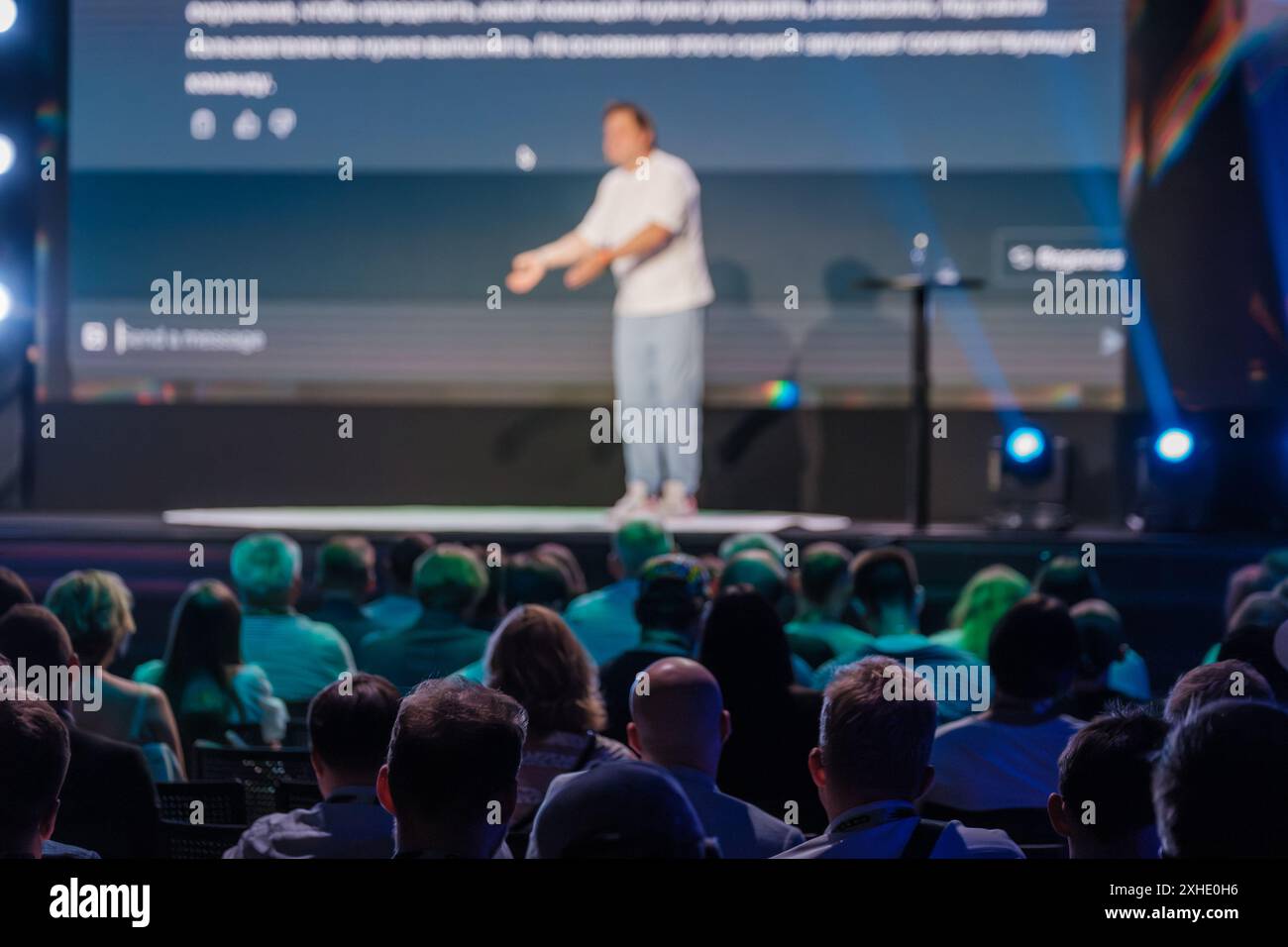 Speaker giving an engaging presentation to a seated audience at a ...