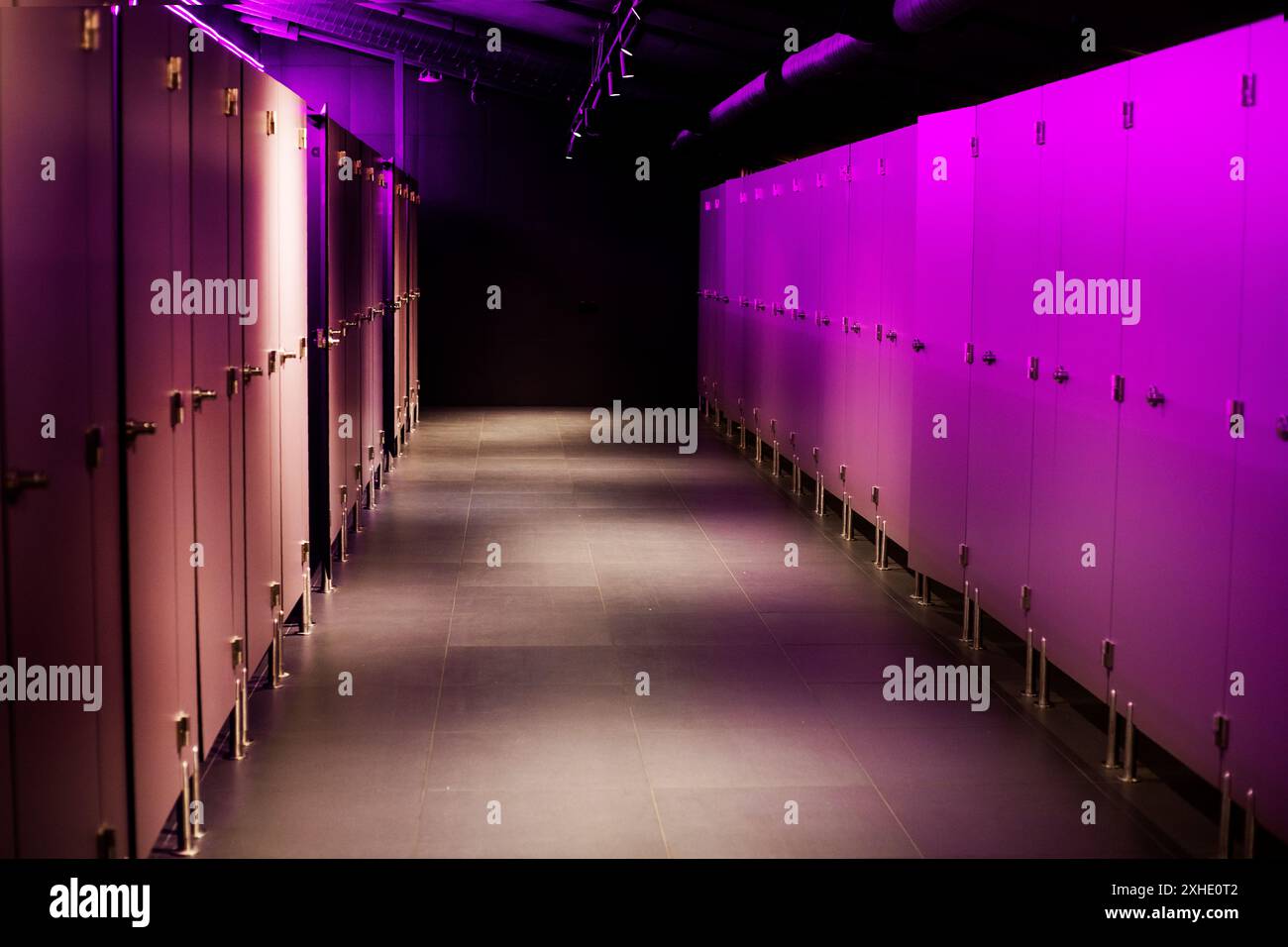 interior in the toilet room with booths with purple lighting in the ...
