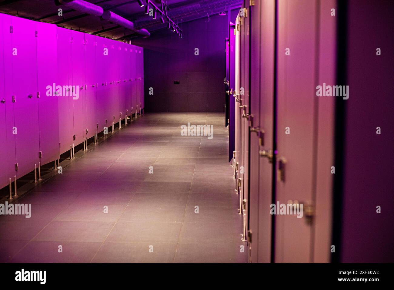 interior in the toilet room with booths with purple lighting in the ...