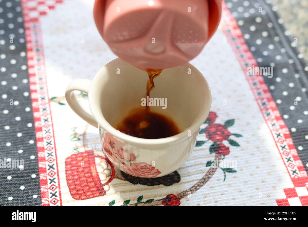 In this photo illustration, a person pours coffee into a cup. The drink ... In this photo illustration, a person pours coffee into a cup. The drink ...