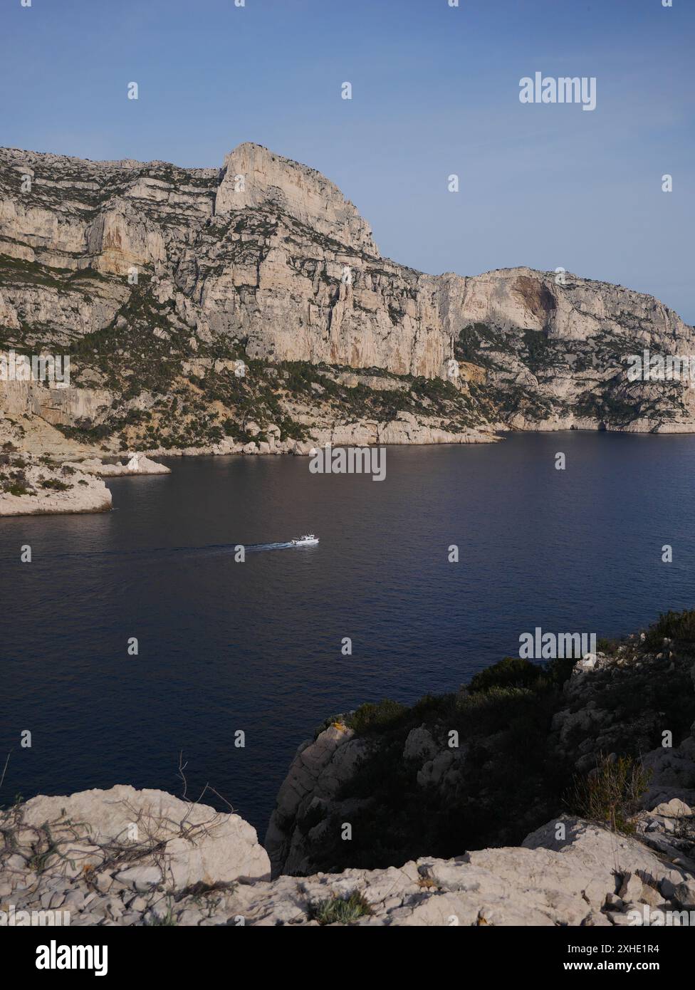 French Calanques in the village of Sormiou, with view of a sailing boat ...