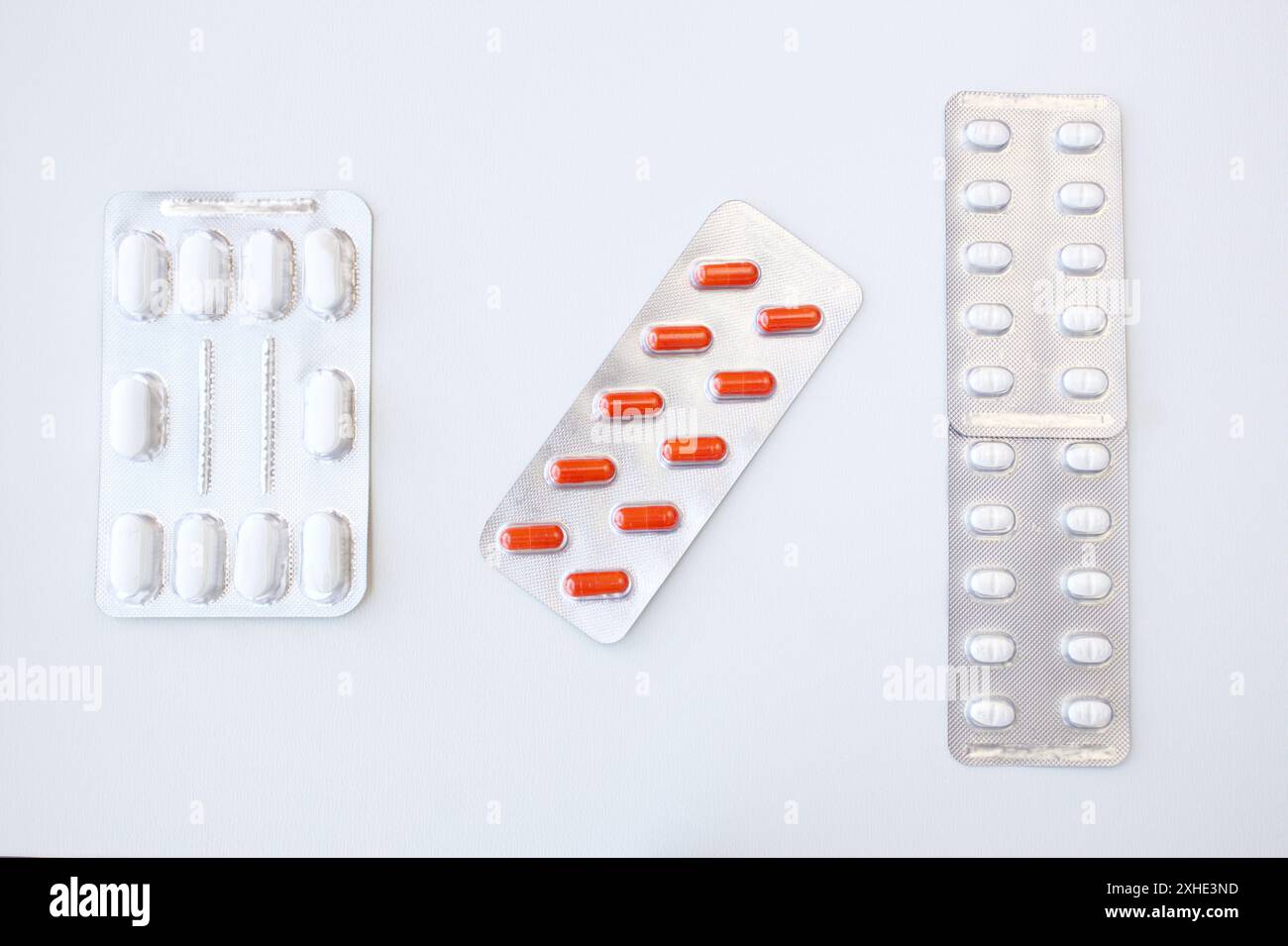 Red and White medical capsules packed in blister isolated on white ...