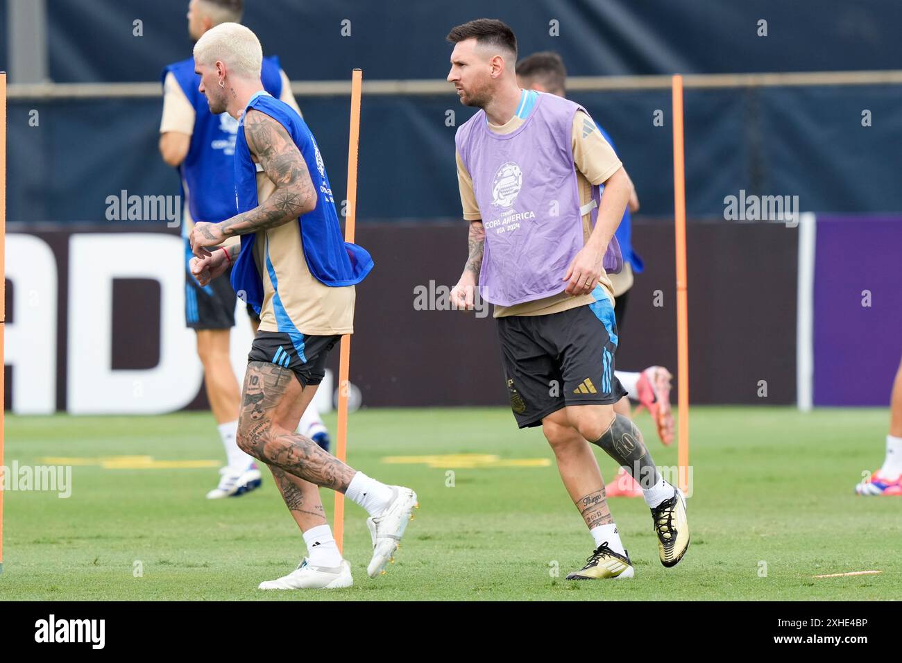 Argentina's Lionel Messi, right, and Rodrigo De Paul warm up during a ...