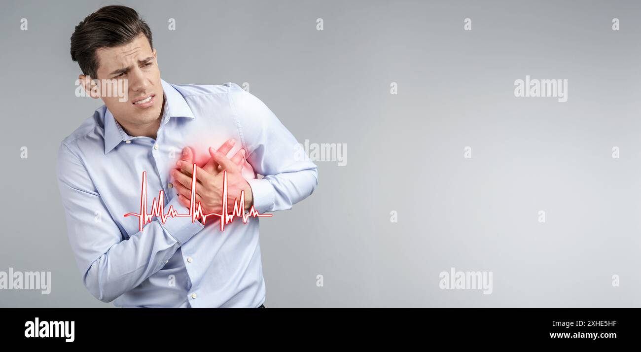 Heart attack. Man writhing in pain and pressing hands to chest on grey ...
