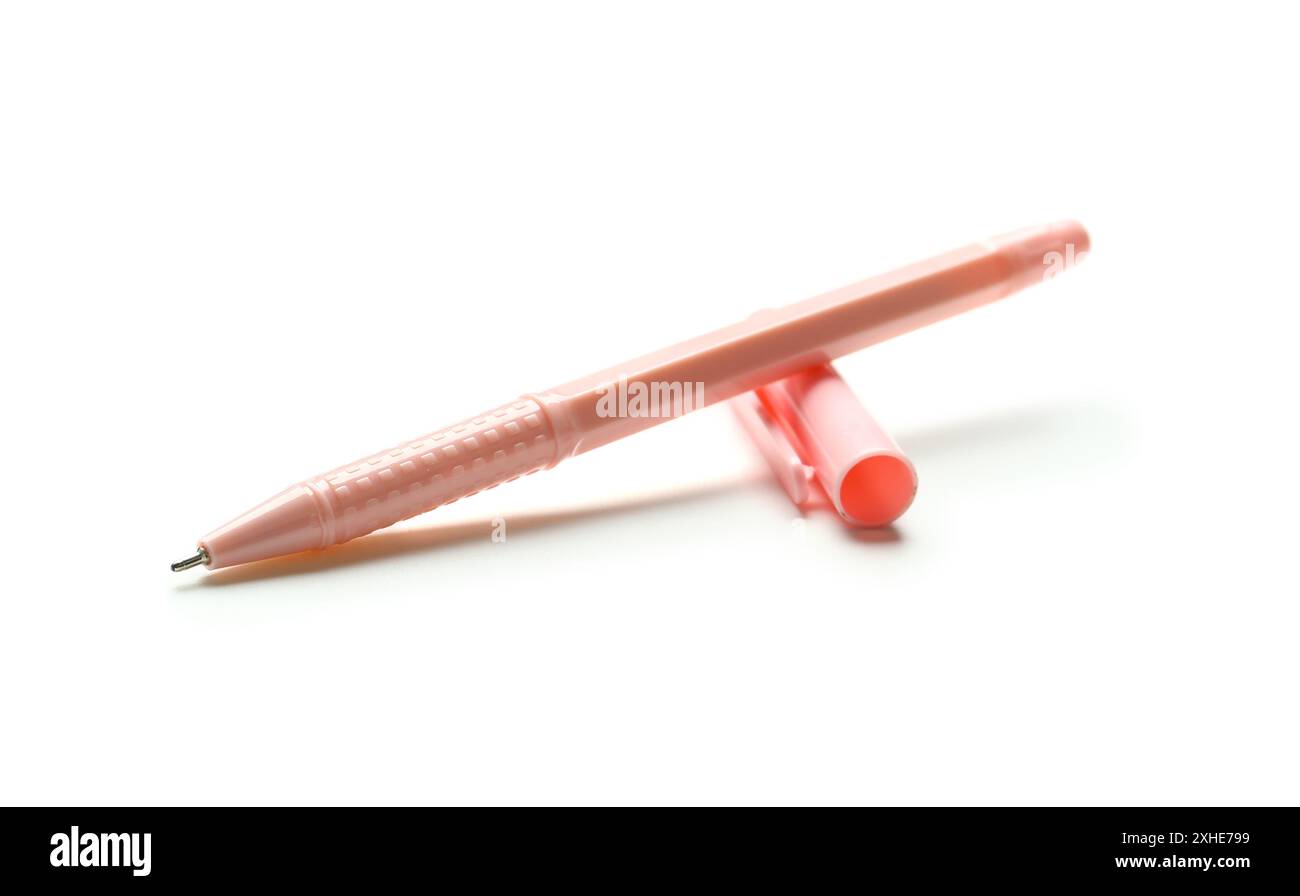 Pink ballpoint pen and cap on white background Stock Photo - Alamy