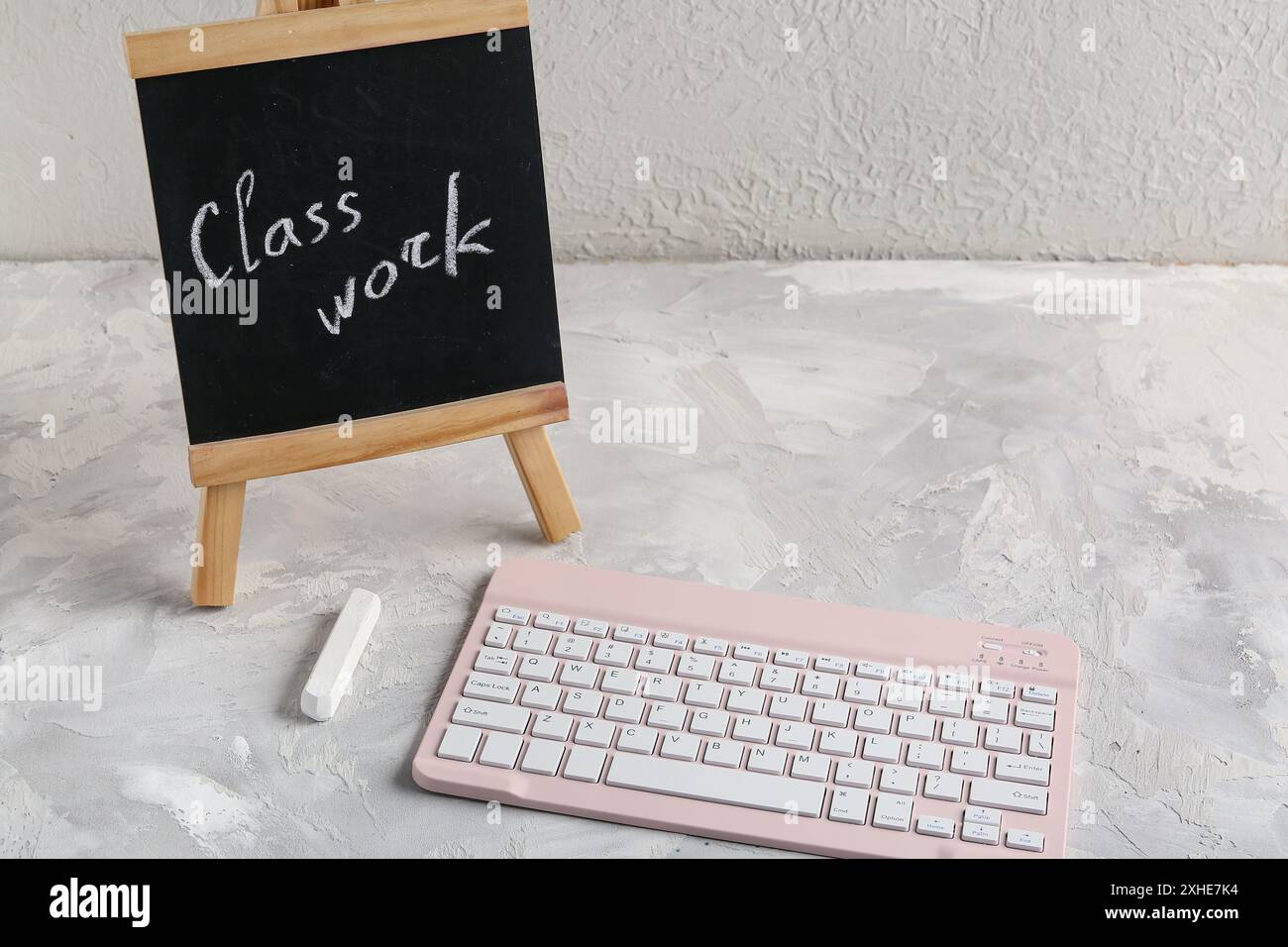 Mini chalkboard with text CLASSWORK and modern keyboard on grunge ...