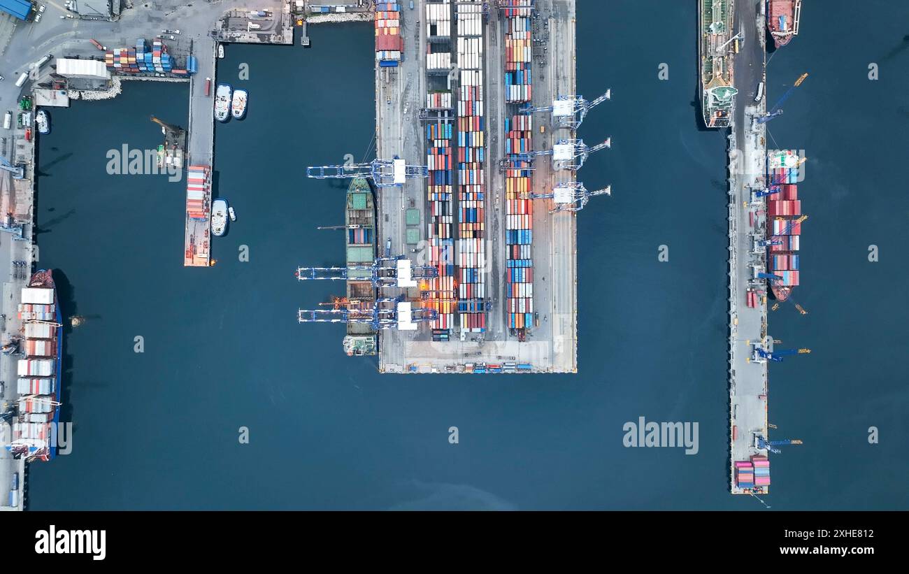 Aerial top view of Container ship loading and unloading, Cargo container in deep seaport for the ...