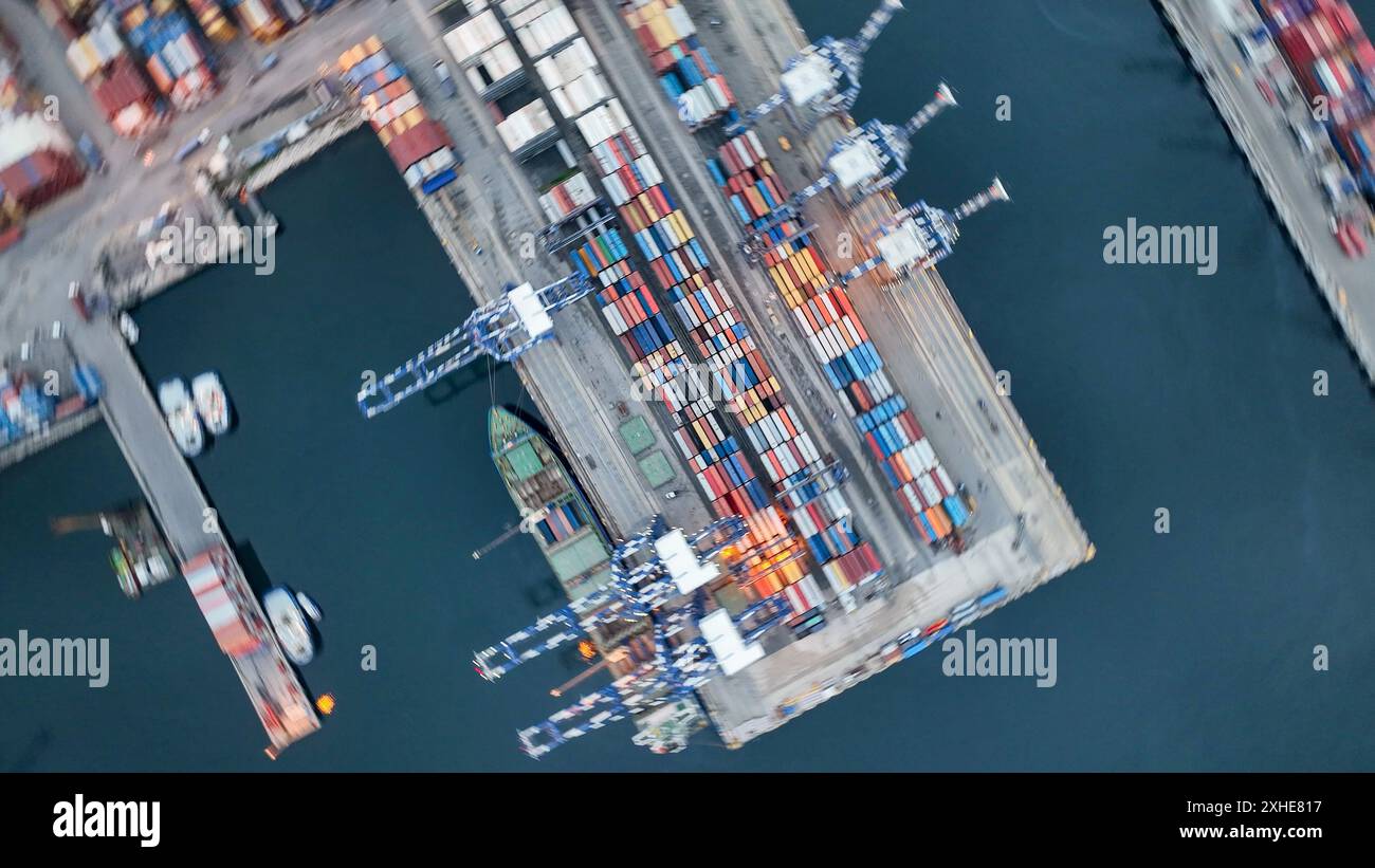 Aerial top view of Container ship loading and unloading, Cargo container in deep seaport for the ...