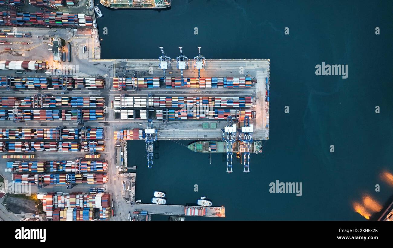 Aerial top view of Container ship loading and unloading, Cargo container in deep seaport for the ...