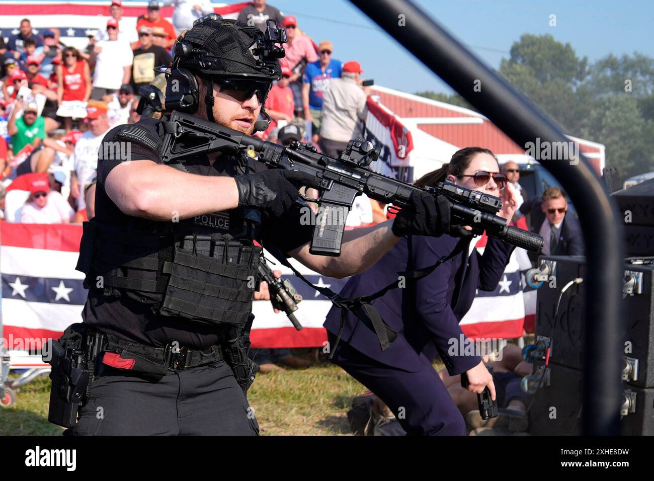 U.S. Secret Service agents surround the stage as other agents cover ...