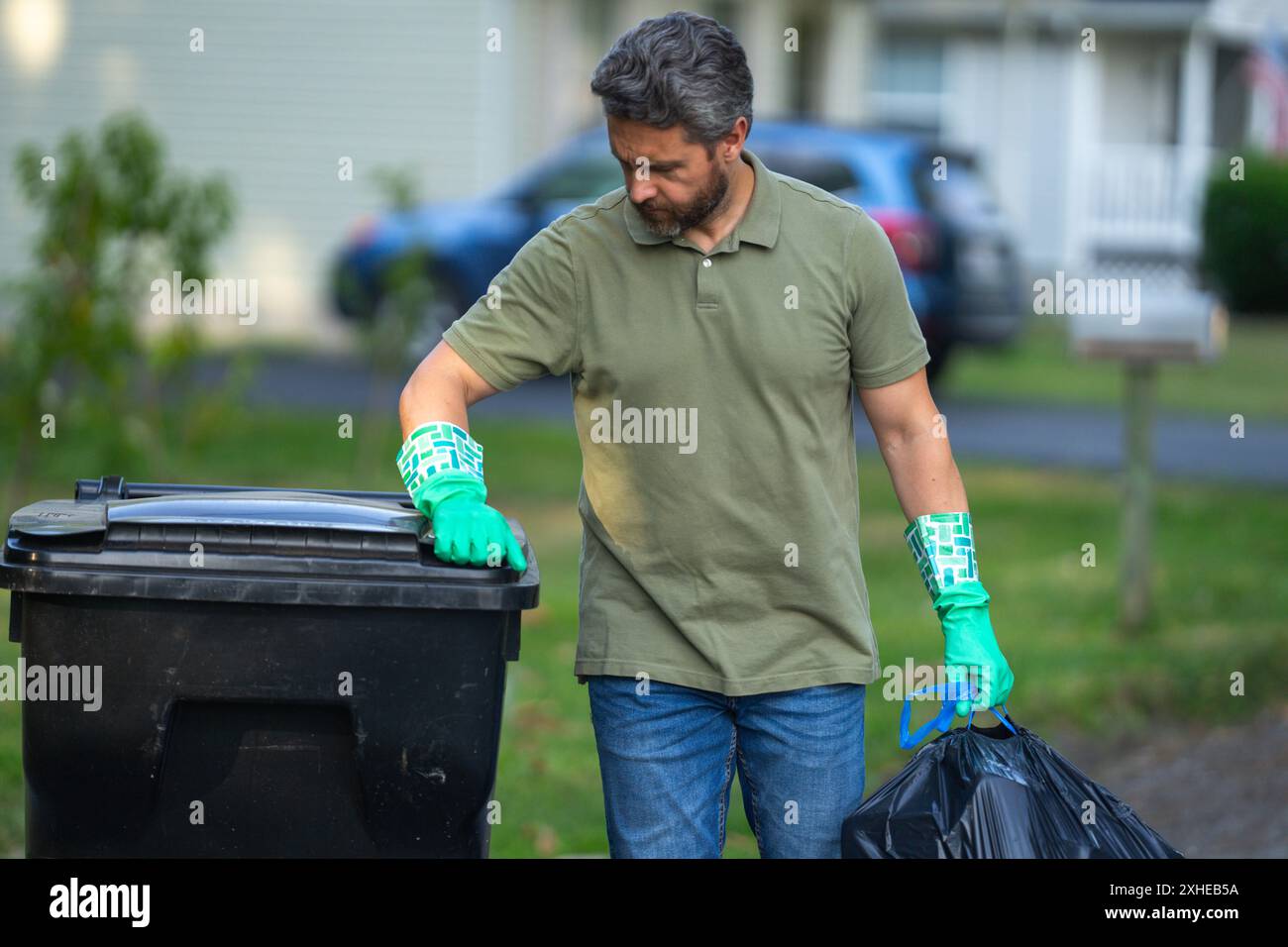 Man with trash bag that contains garbage. Waste management. Daily ...