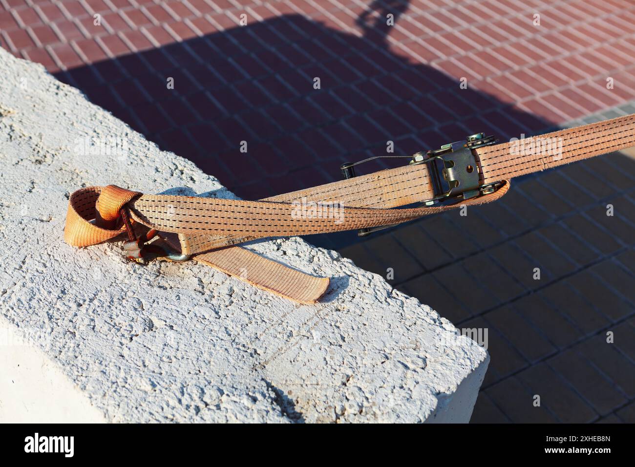 Rope is tied to a cement block. Wall Mounted Belt Barrier Stock Photo ...